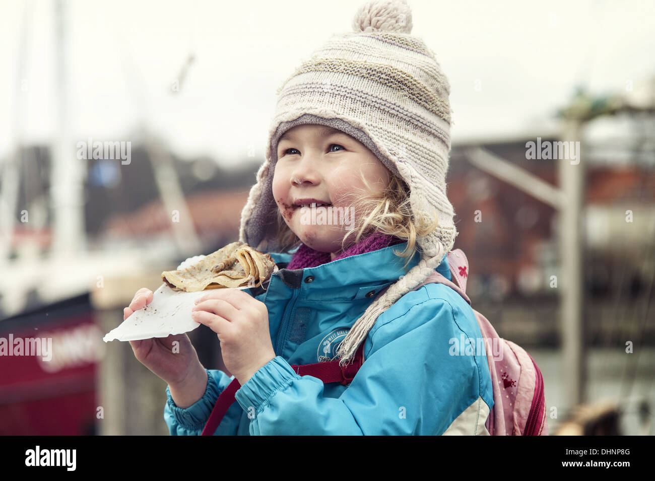 a little girl eating a crepe Stock Photo - Alamy