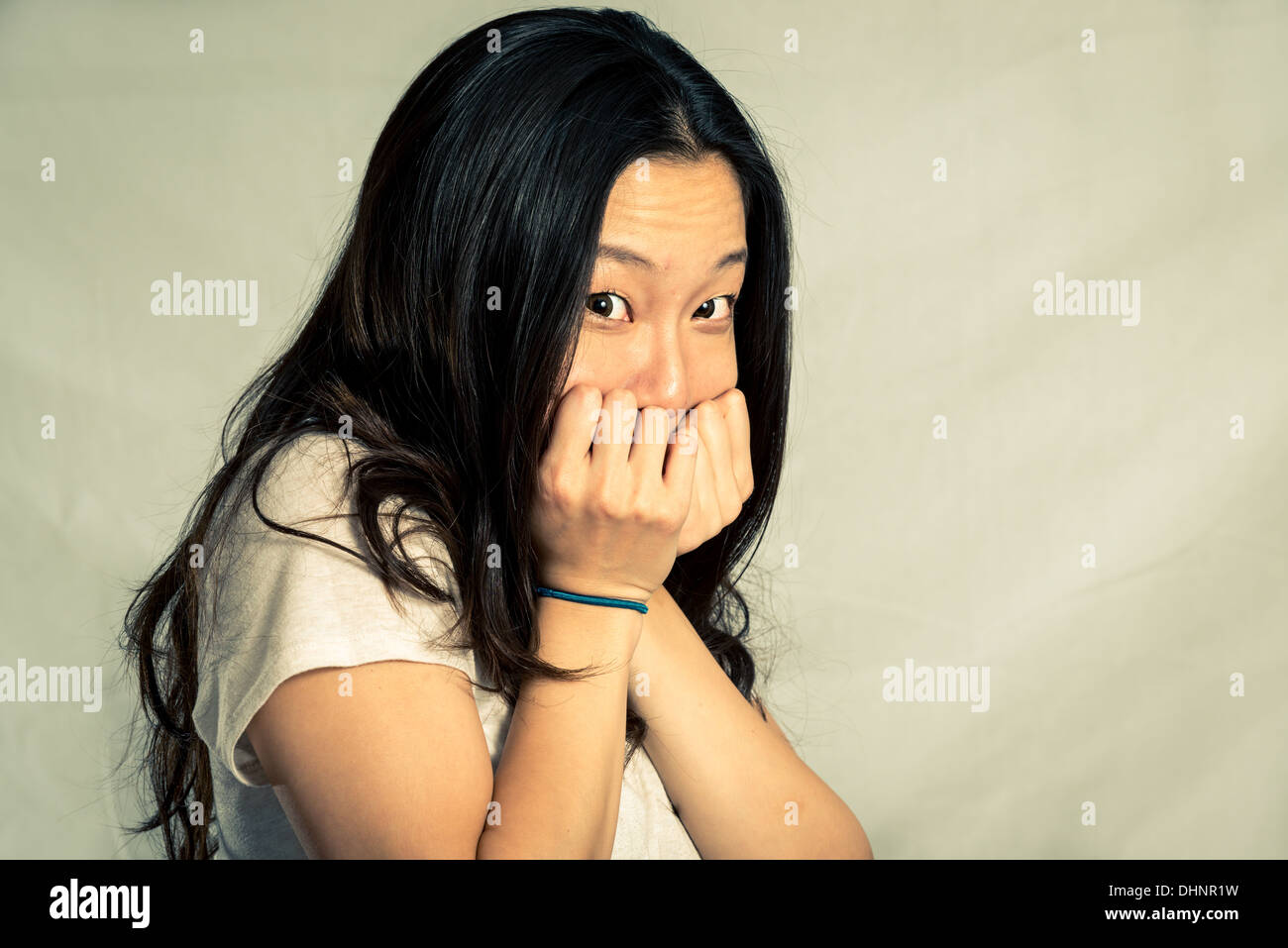 Young woman covering her face, with fashion tone and background Stock ...