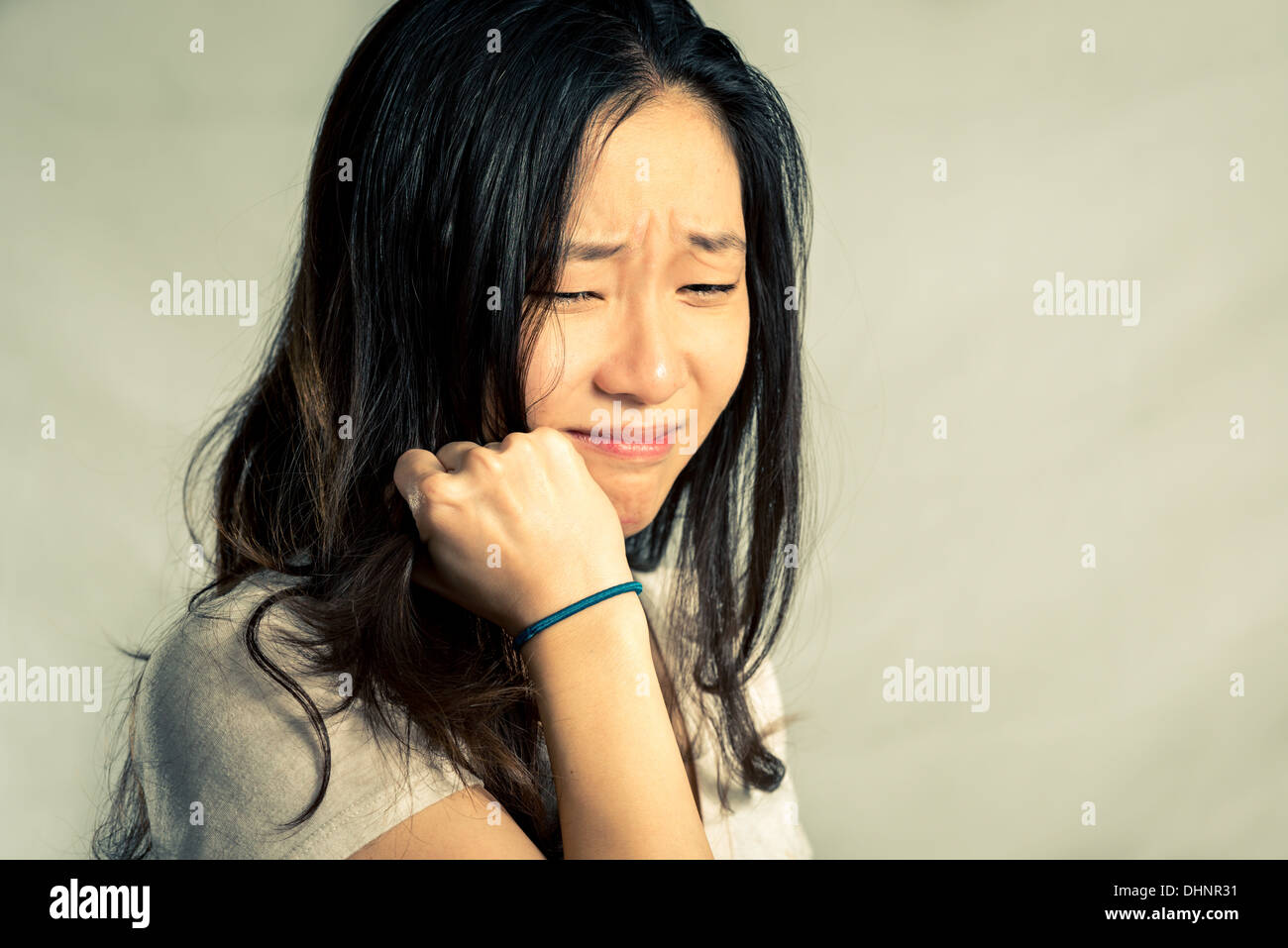Young woman crying while pulling her hair, with fashion tone and ...