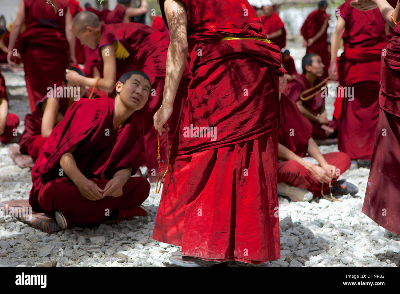 Young Tibetan Buddhist monks debating in the Debating Courtyard at Sera ...