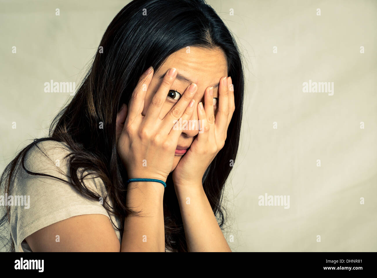 Young woman covering her face, with fashion tone and background Stock ...