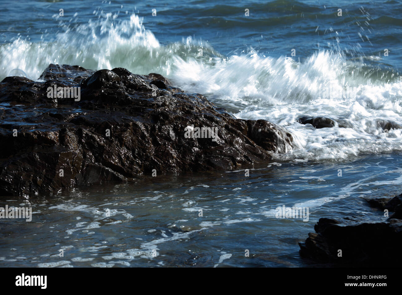 Waves breaking on rocks Stock Photo - Alamy