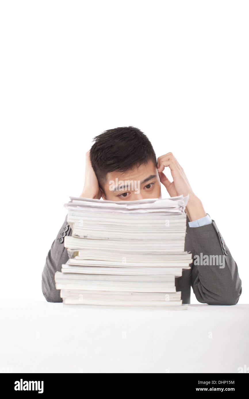 Businessman with large pile of paper work Stock Photo - Alamy