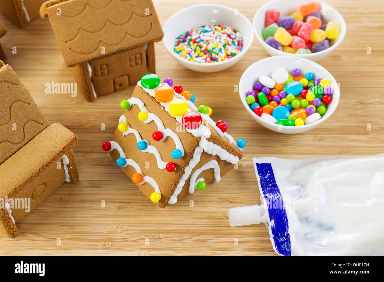 Horizontal photo of parts of Gingerbread houses being assembled with ...