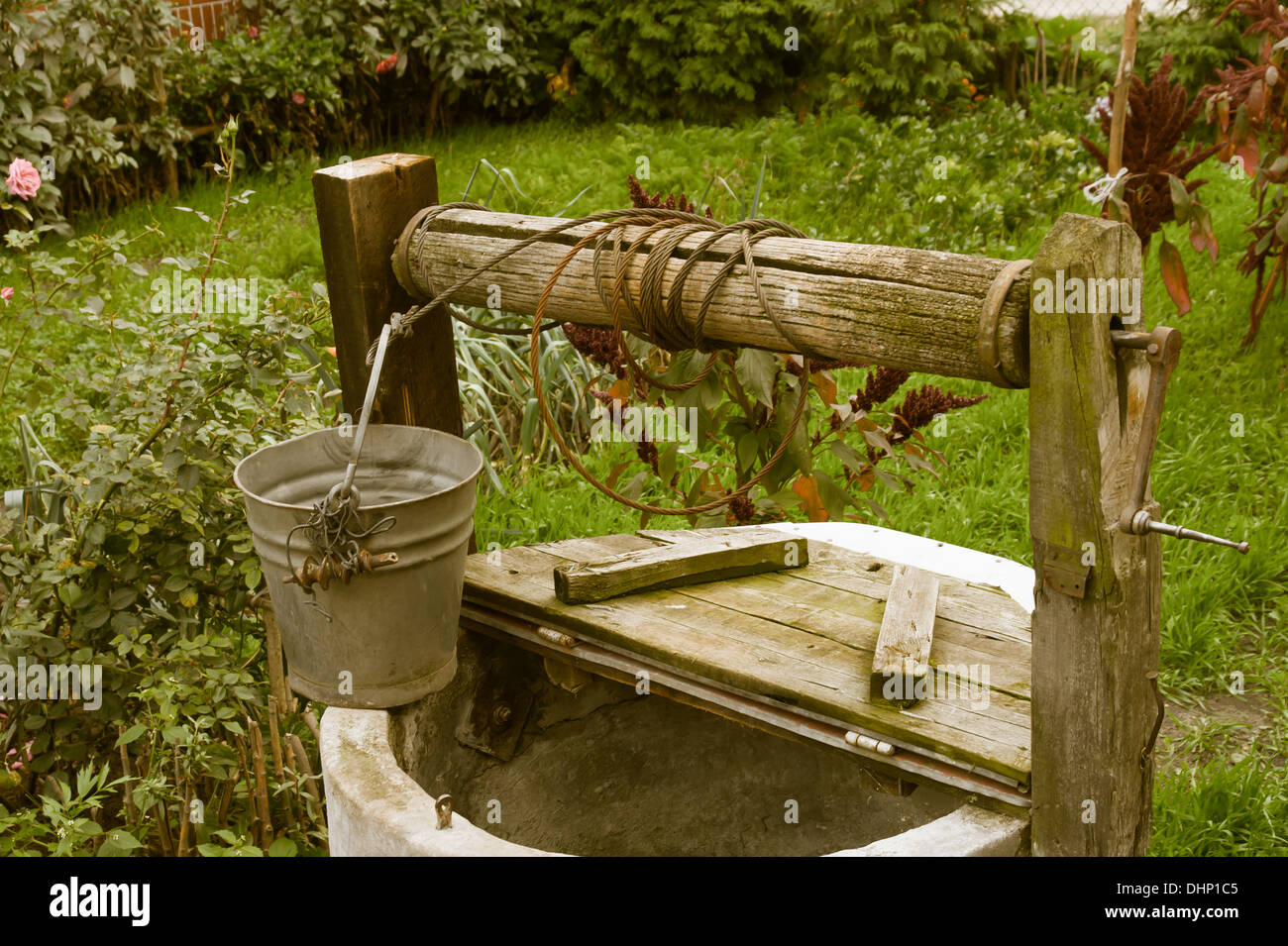 old rotten water well in sumer garden, rural scenery Stock Photo - Alamy