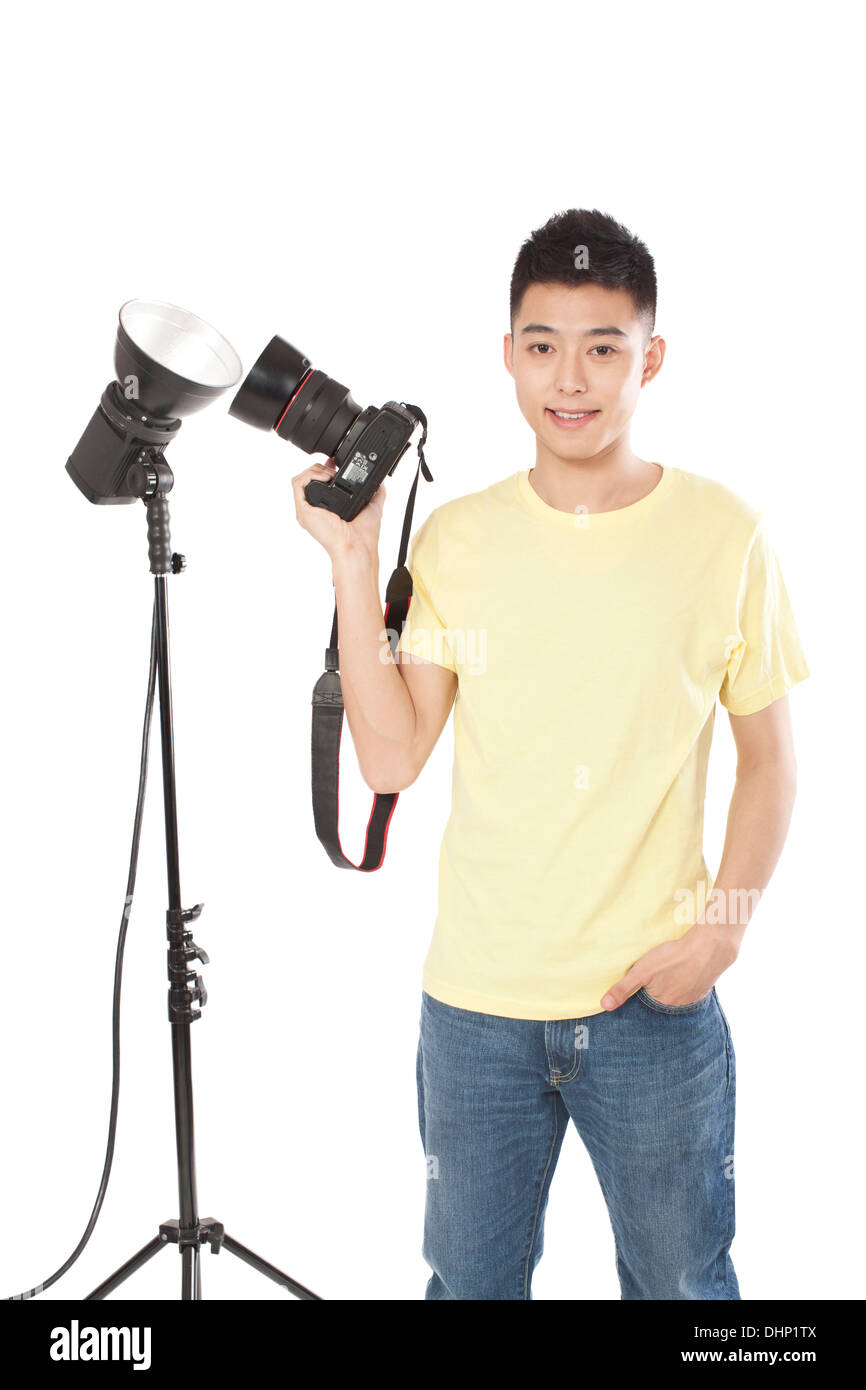 Photographer holding a camera Stock Photo - Alamy