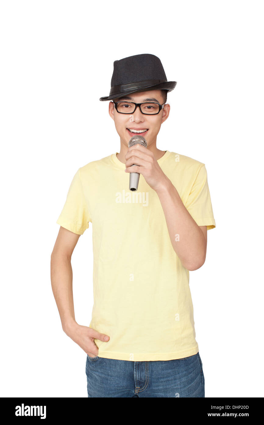 Young man singing into microphone Stock Photo - Alamy