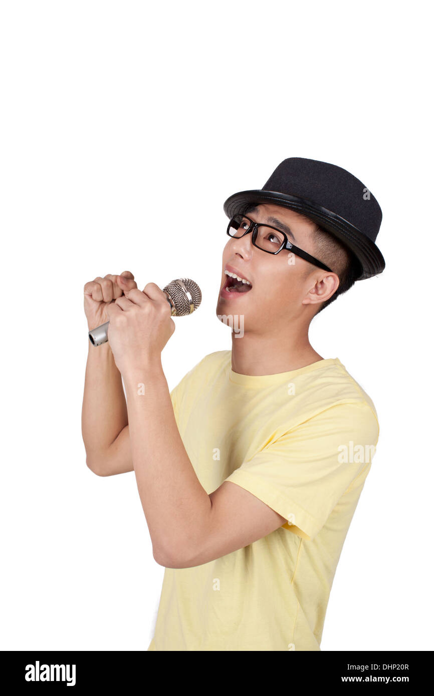 Young man singing into microphone Stock Photo - Alamy