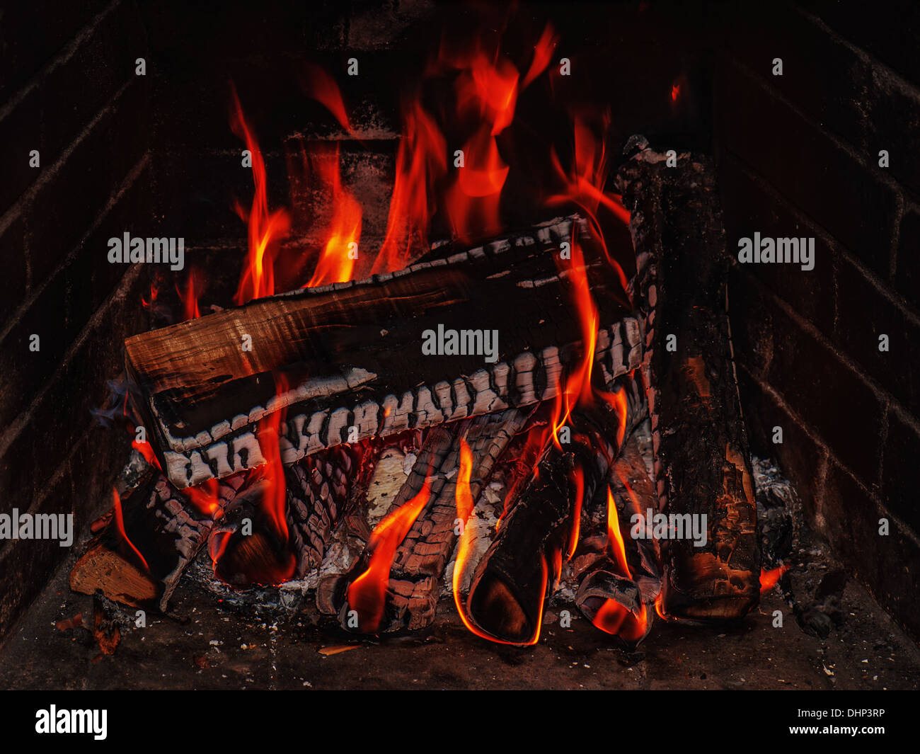 Fireplace with birch firewood and flame. Closeup Stock Photo - Alamy