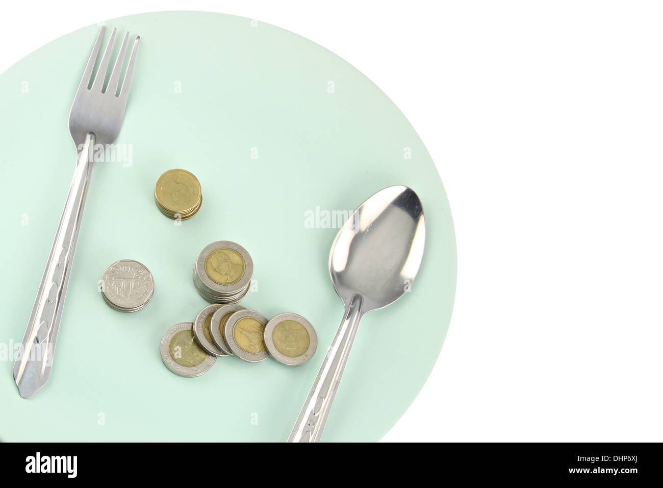 The money is in the green plate and Spoon and fork Stock Photo - Alamy