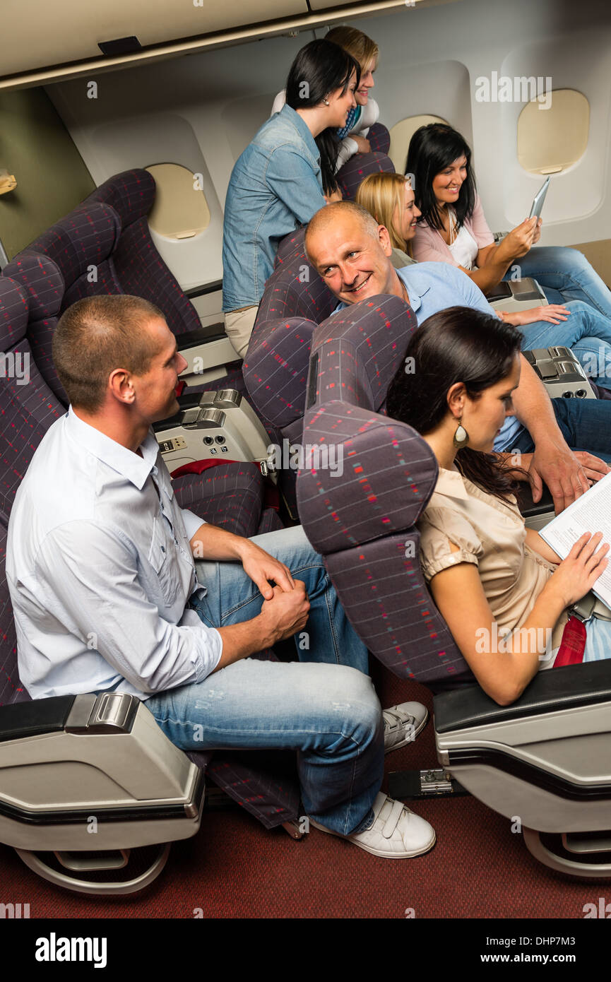 Leisure travel people enjoy flight airplane cabin talking passengers ...