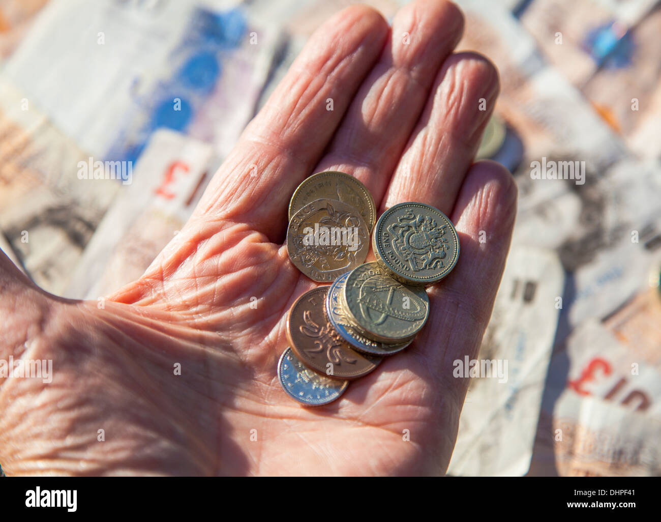 Open hand holding coins Stock Photo - Alamy
