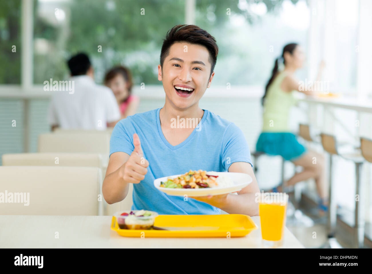 Young man doing thumbs up for good taste Stock Photo - Alamy