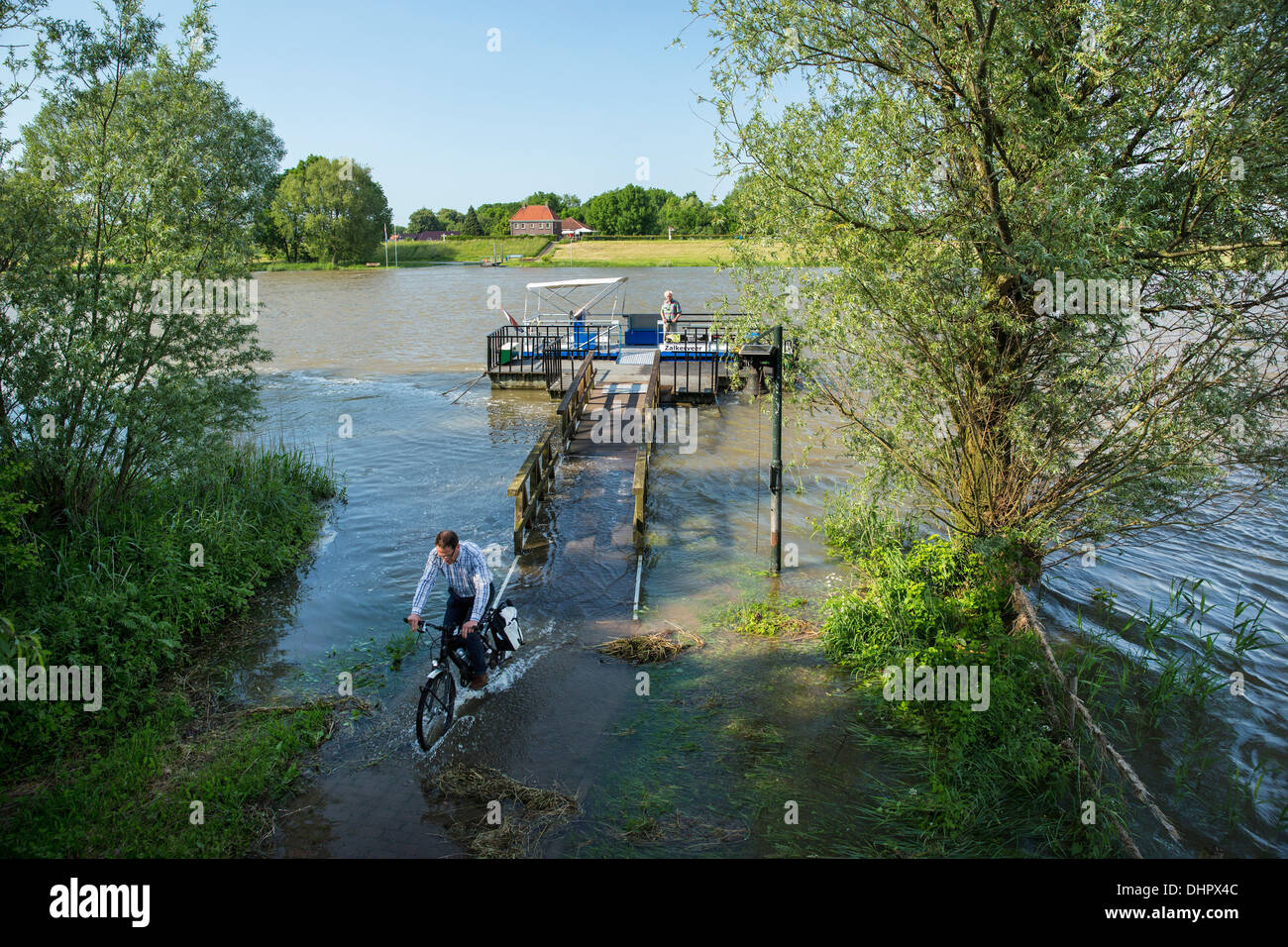 Netherlands, Zalk, Small ferry for pedestrians and cyclists crossing ...