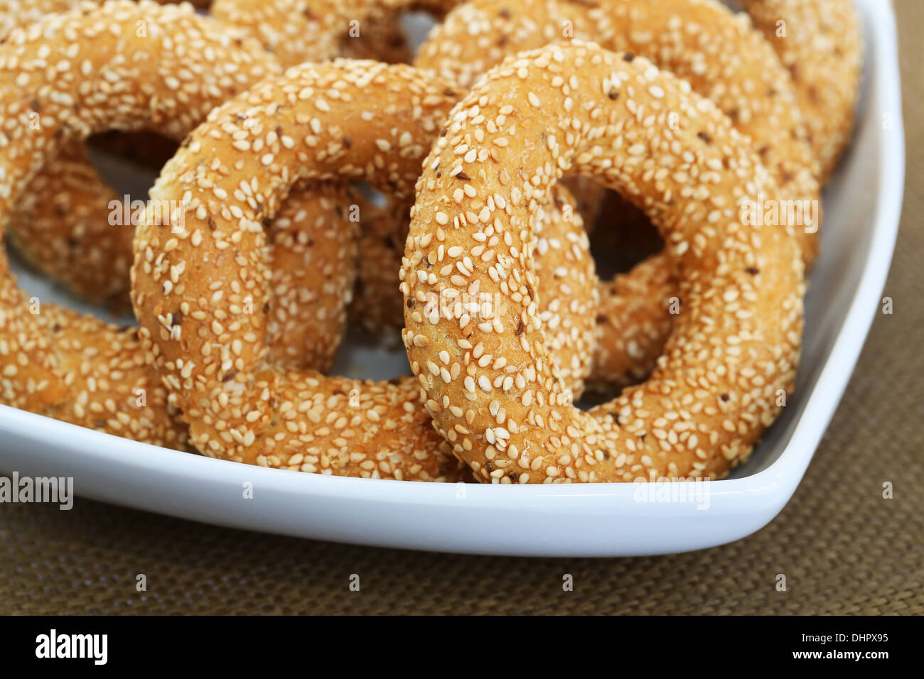 Round rusks with sesame seeds in white bowl Stock Photo - Alamy