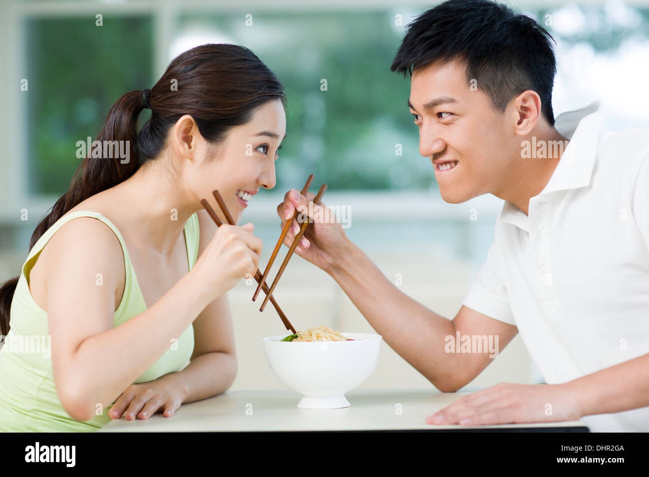 Young couple having noodles in restaurant Stock Photo - Alamy
