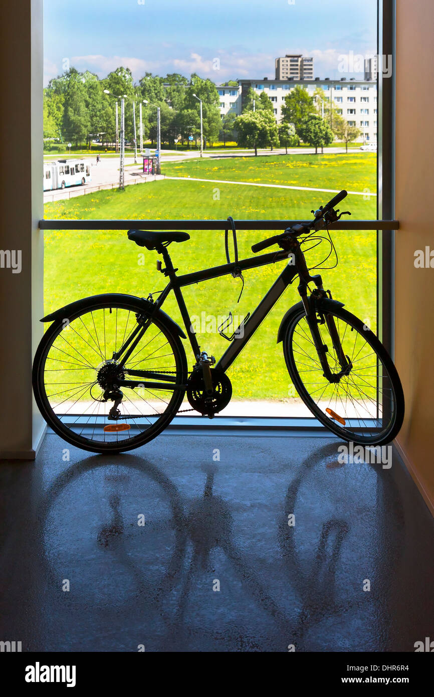 Cycling, parked bicycle at window. Figure, slihouette at window ...