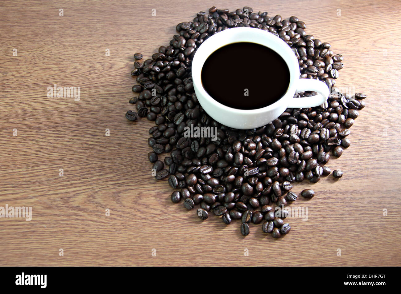 The Picture White coffee cup resting on coffee beans Stock Photo - Alamy
