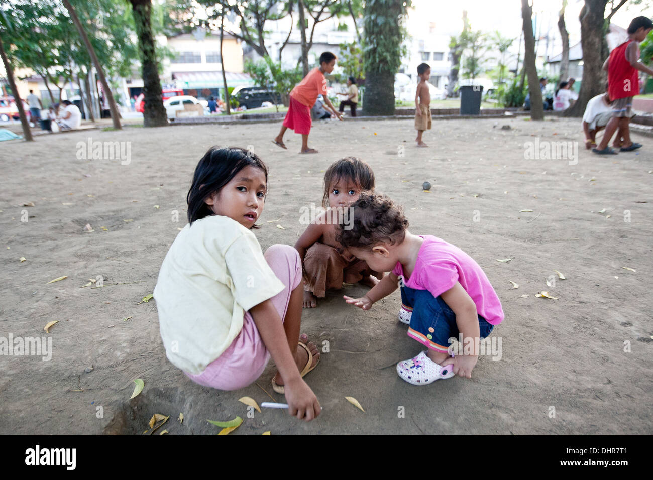 Two local girls and an OMF kid play together on the street of Davao ...
