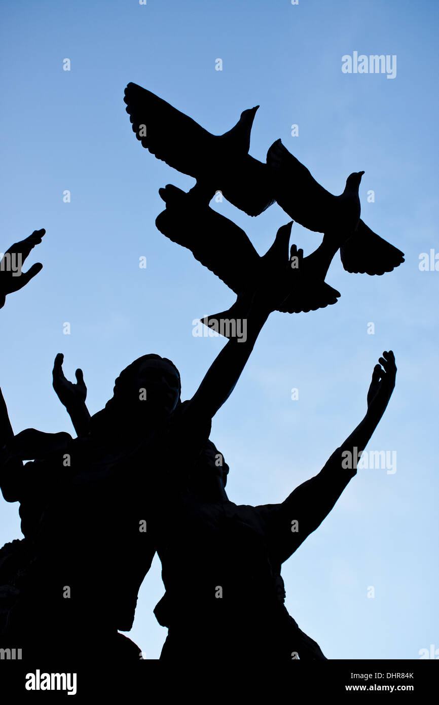 A statue is silhouetted against the sky in downtown Davao Stock Photo ...
