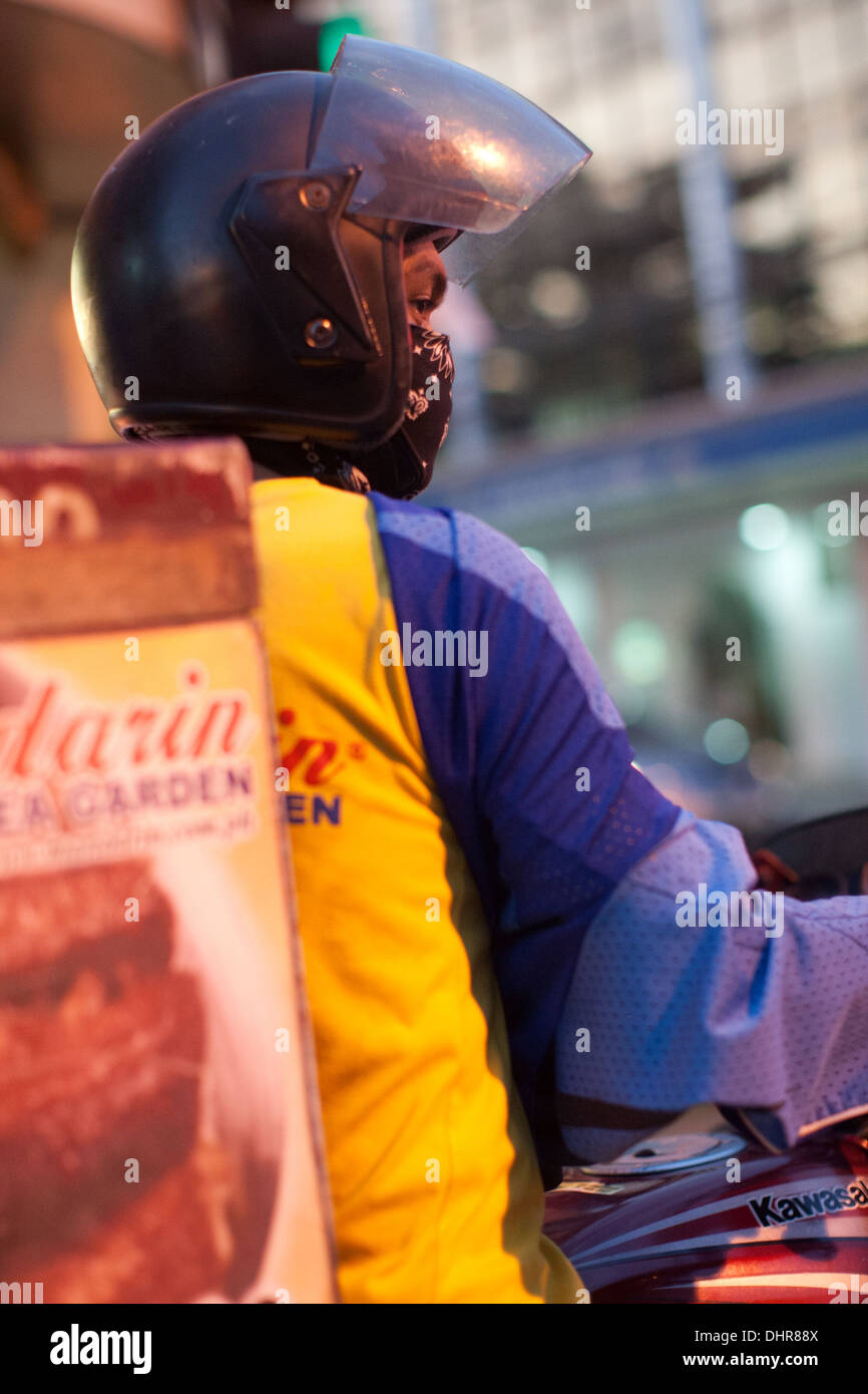 A food delivery driver waits in traffic in downtown Davao Stock Photo ...