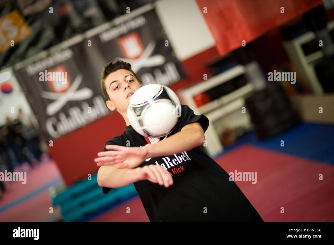 Soccer freestyler Marcel Gurk lies on his back and balances a ball on ...