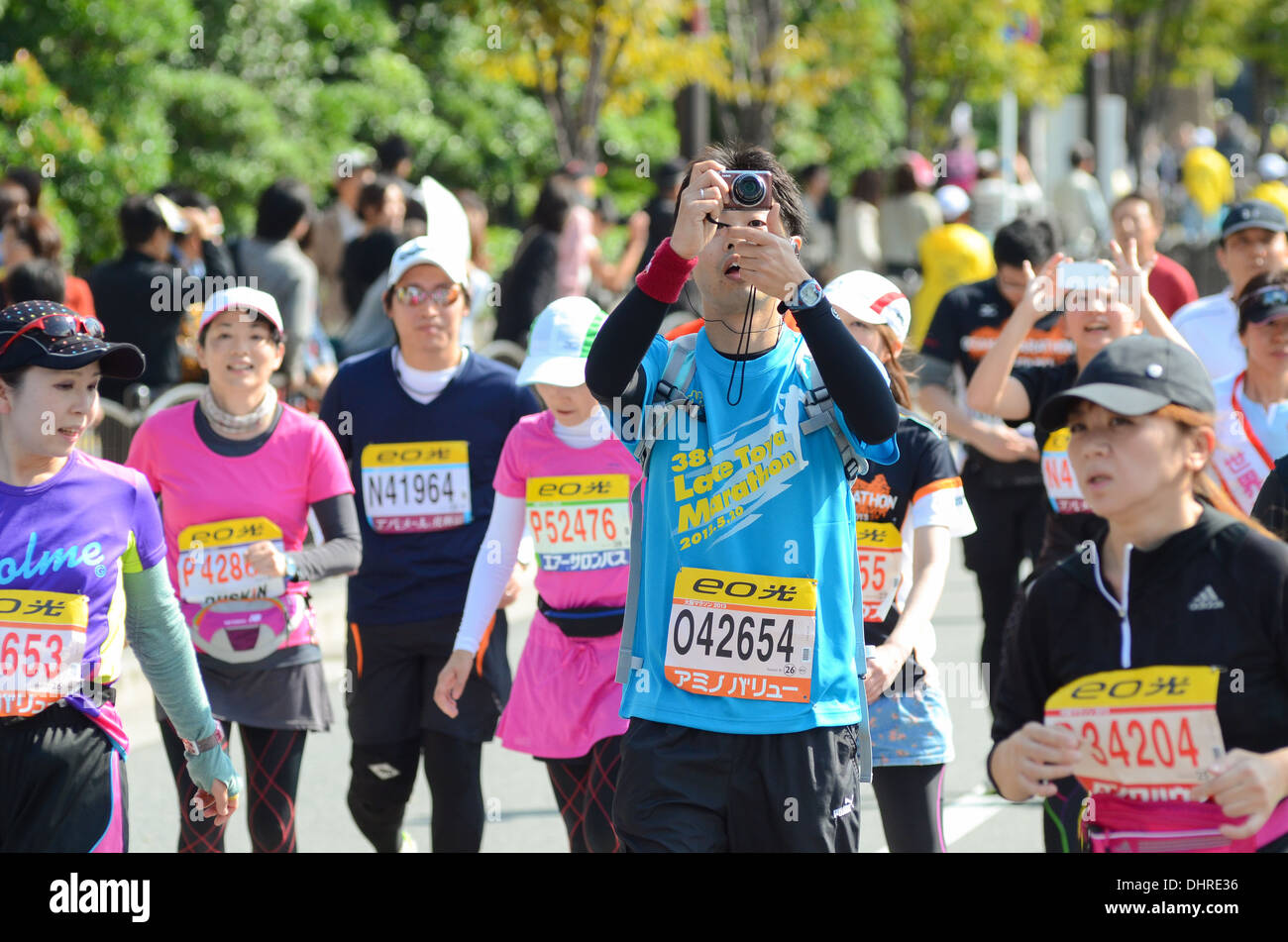 A runner taking a photograph during a marathon in Osaka, Japan Stock ...