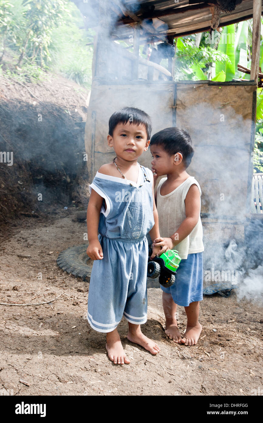 Children play outside their home in a village on the outskirts of Davao ...