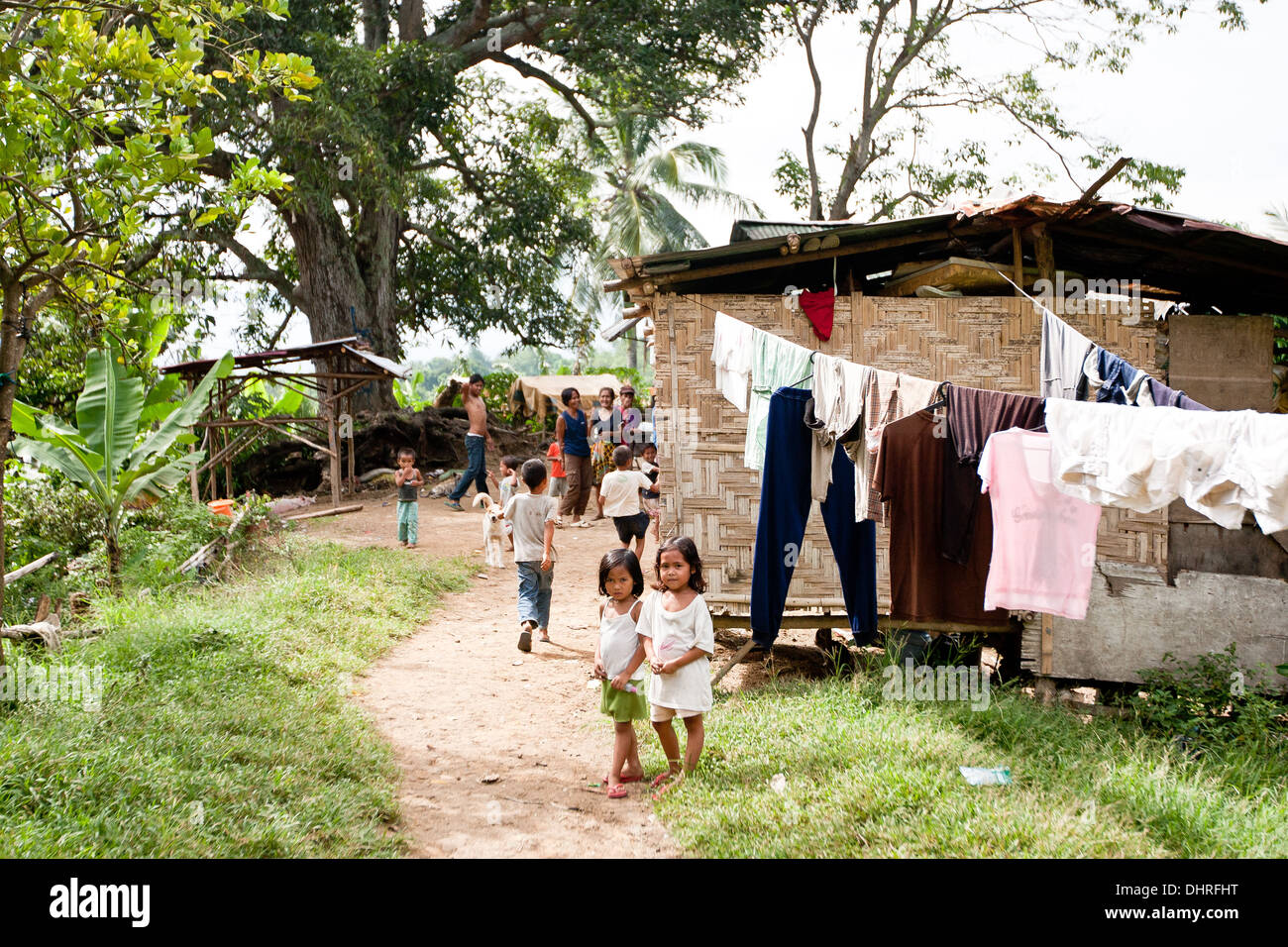 Children play outside their home in a village on the outskirts of Davao ...