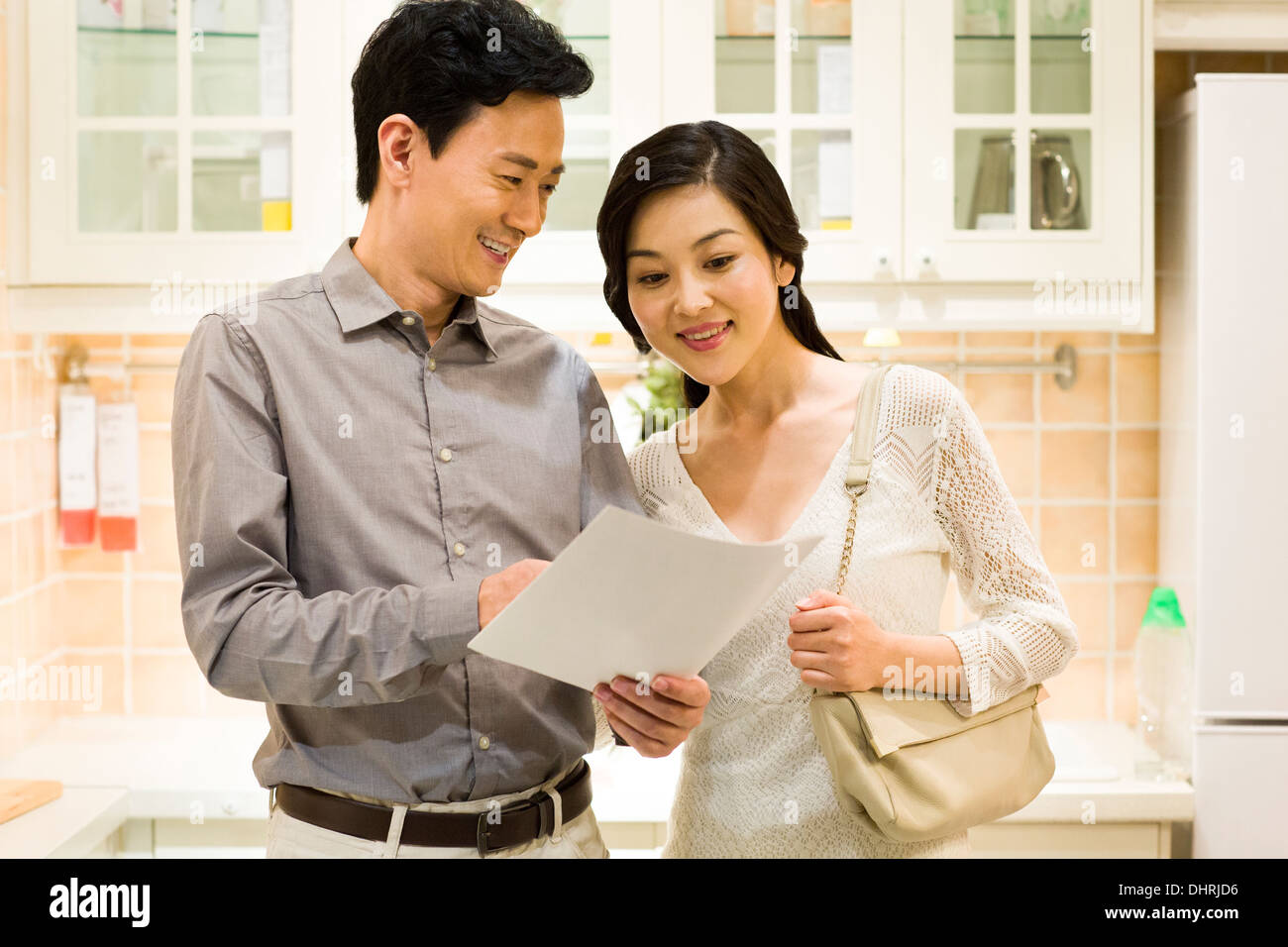 Happy couple reading instructions Stock Photo - Alamy