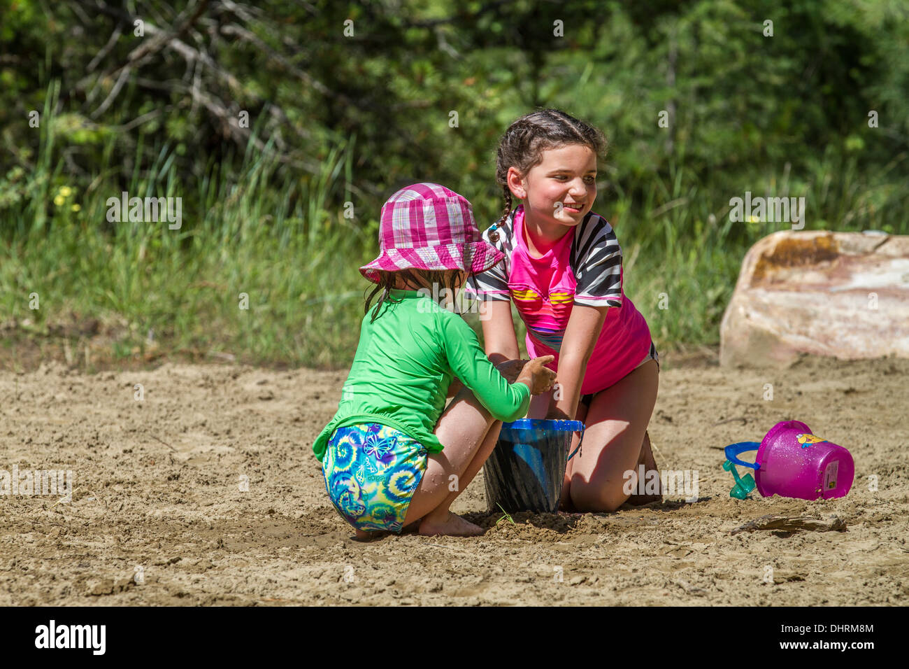 Two pretty preteen girls, model released, playing on the beach, in ...
