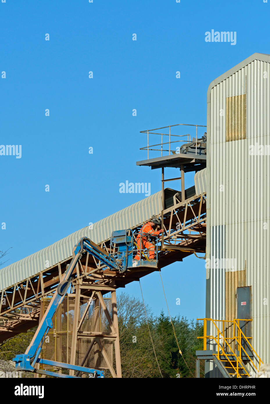 Man working on conveyor. Shap Beck Quarry, Shap, Cumbria, England ...