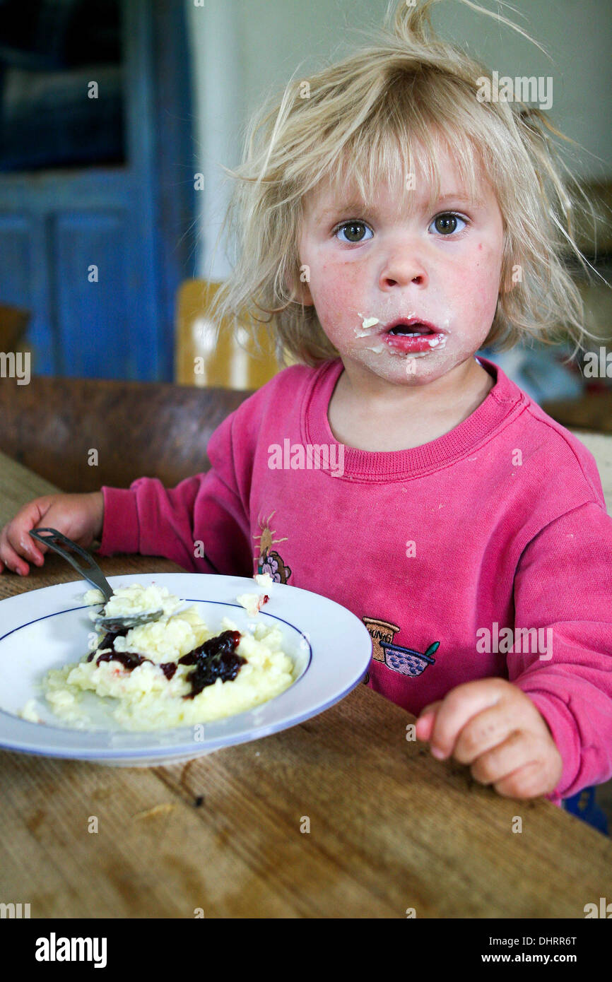Little boy with his face smeared by Semolina pudding Stock Photo - Alamy