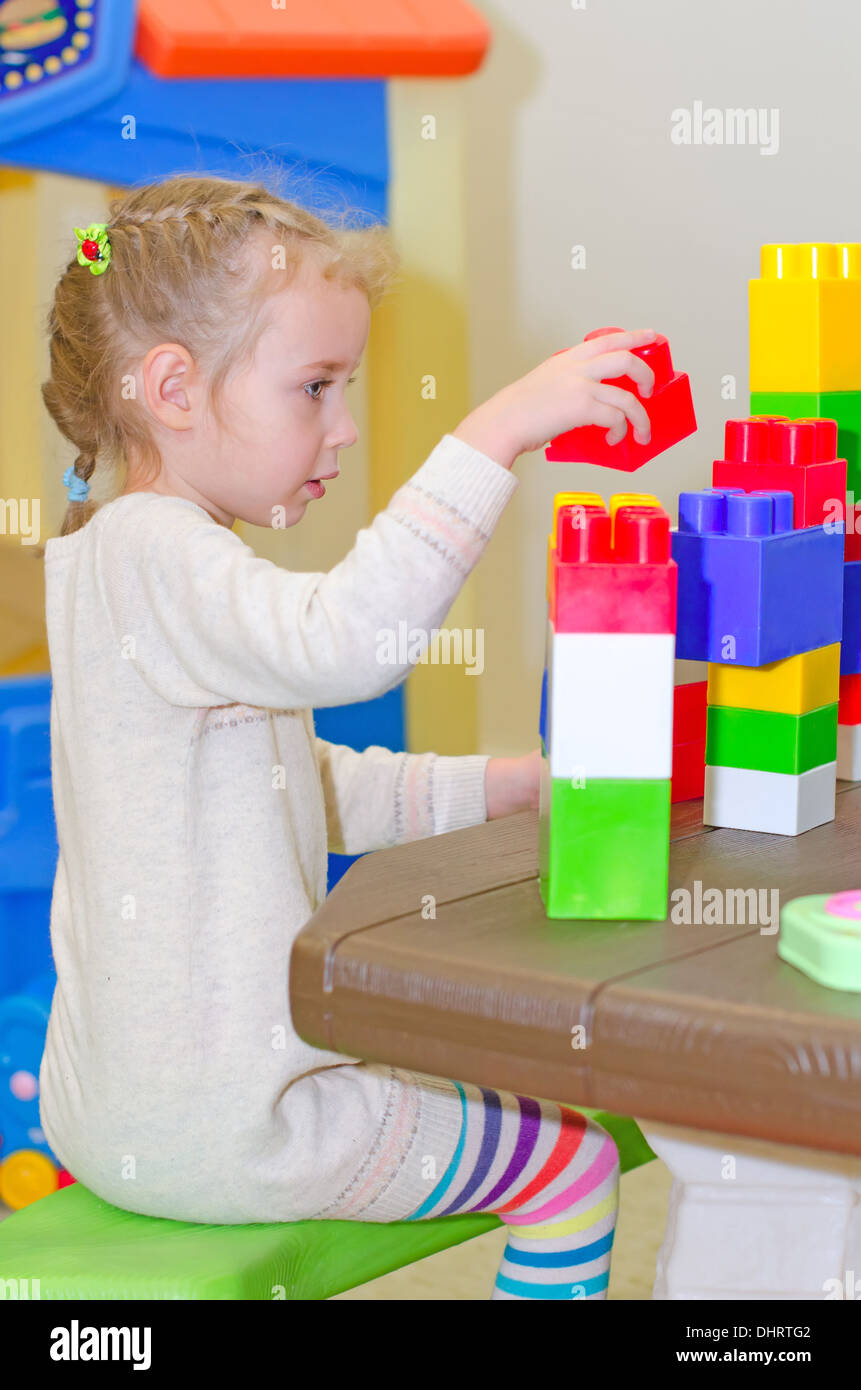 Little girl playing with building blocks Stock Photo - Alamy