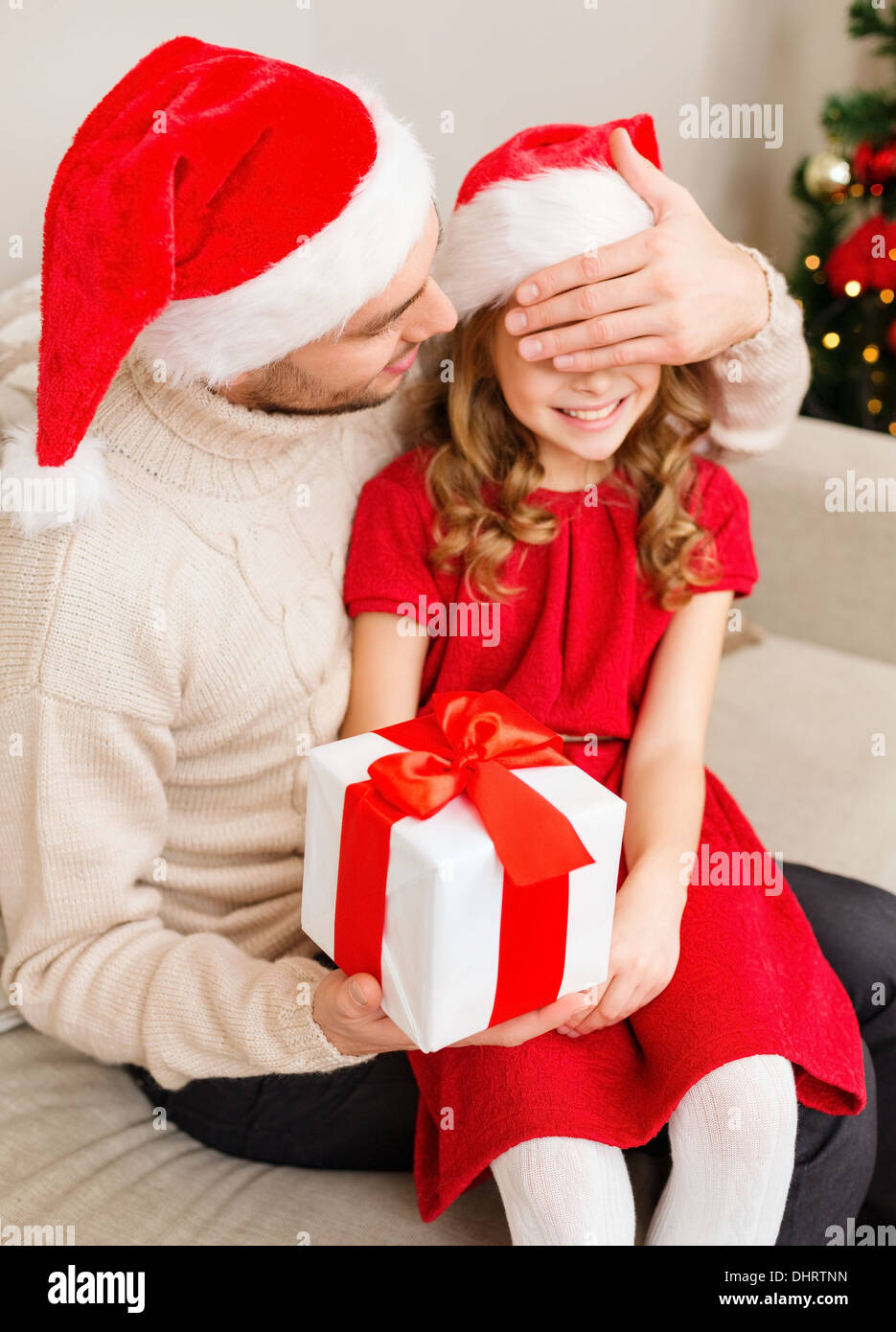 smiling father surprises daughter with gift box Stock Photo - Alamy