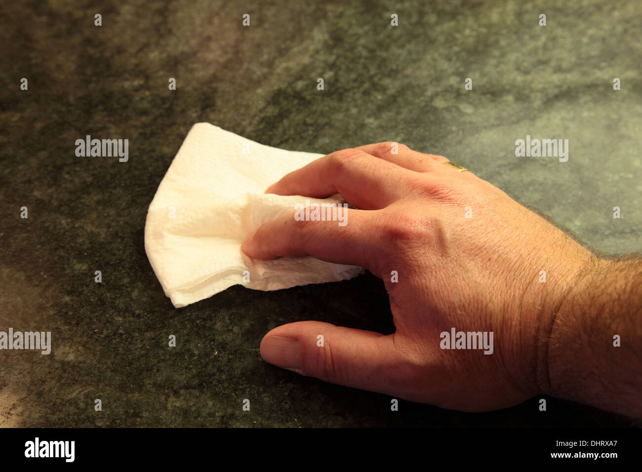 Hand with cloth wiping kitchen surface Stock Photo - Alamy