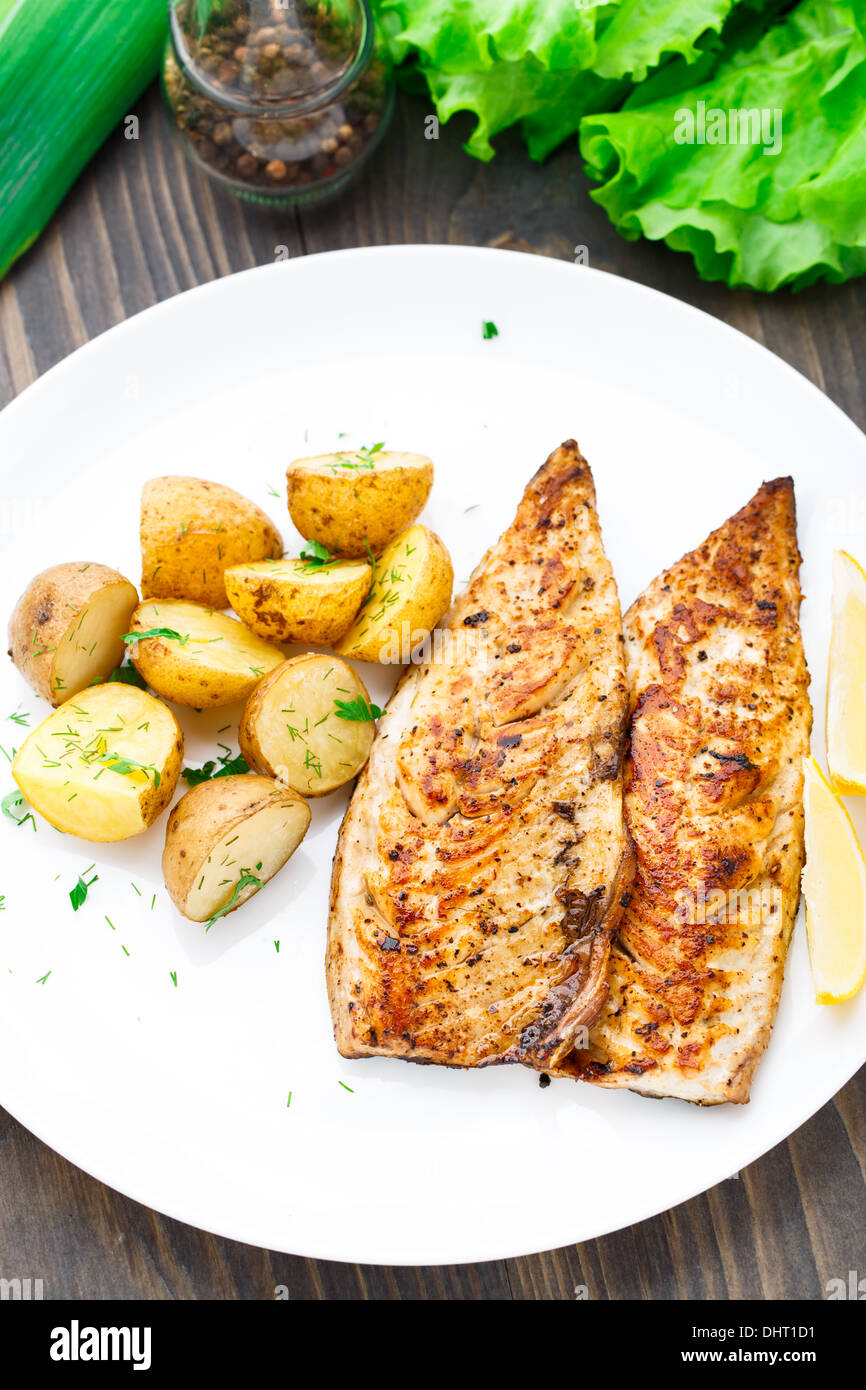 Fried mackerel with baked potato Stock Photo - Alamy