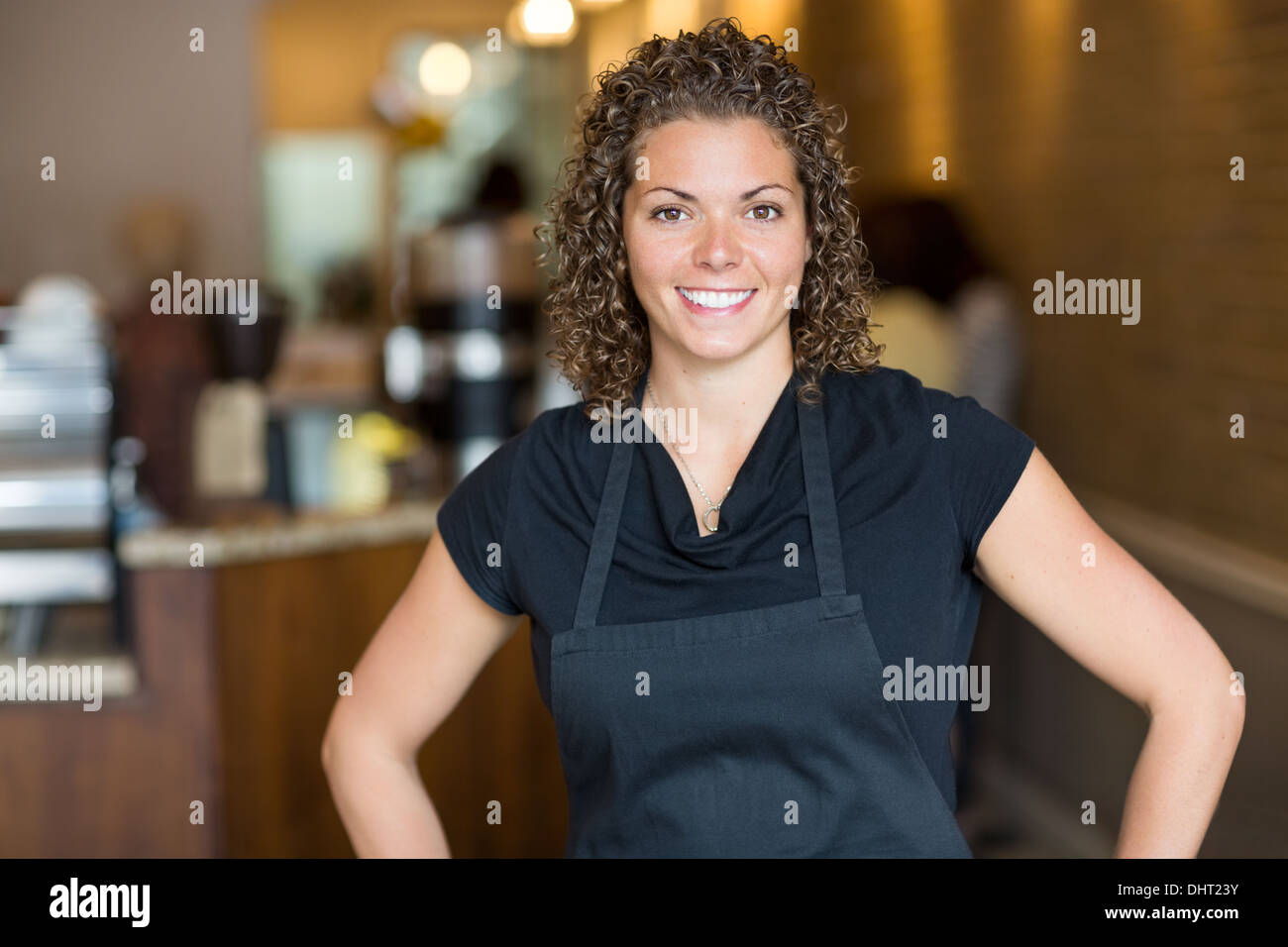 Happy Waitress Standing In Cafe Stock Photo - Alamy