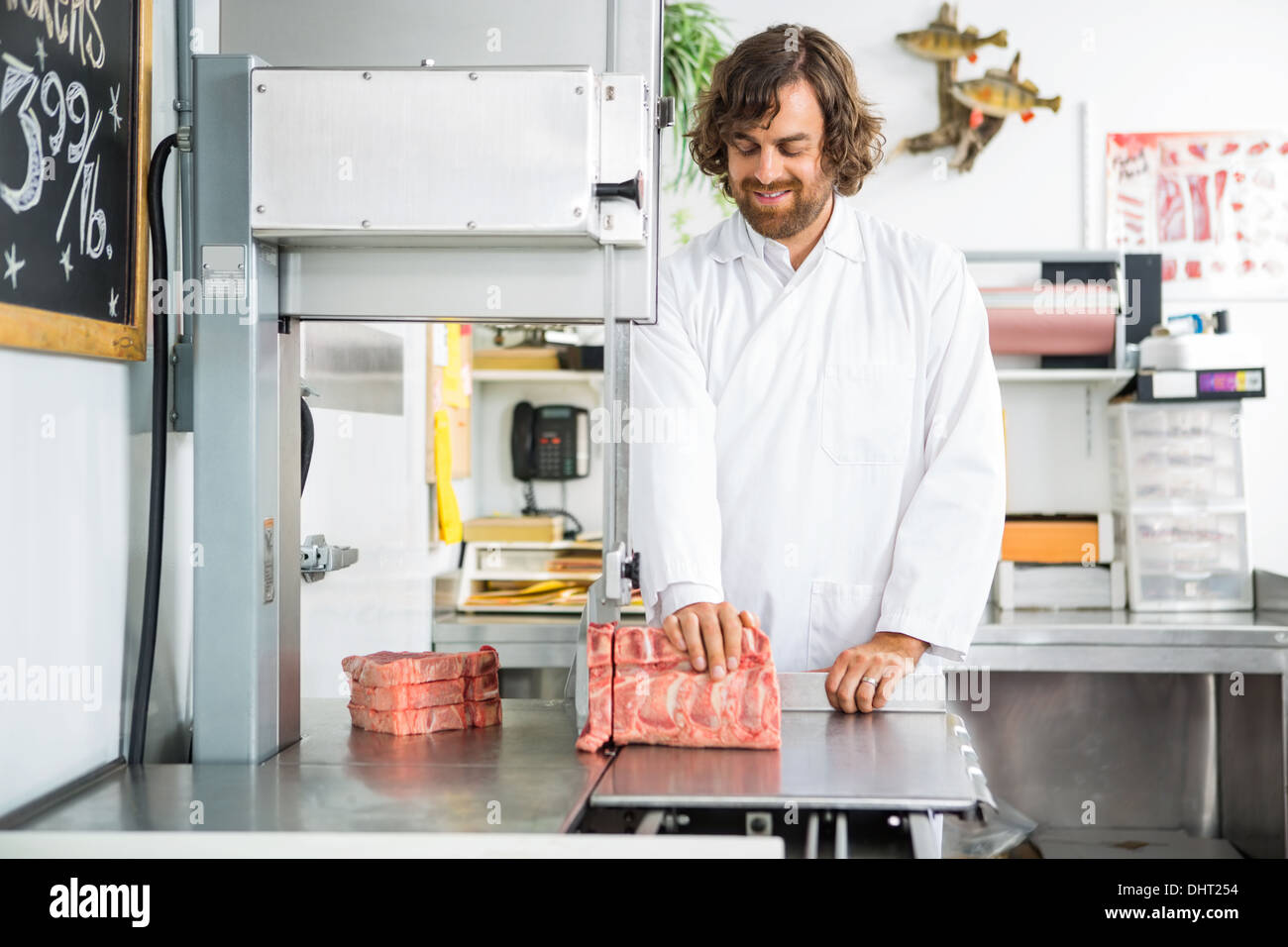 Smiling Butcher Slicing Meat In Machine Stock Photo - Alamy