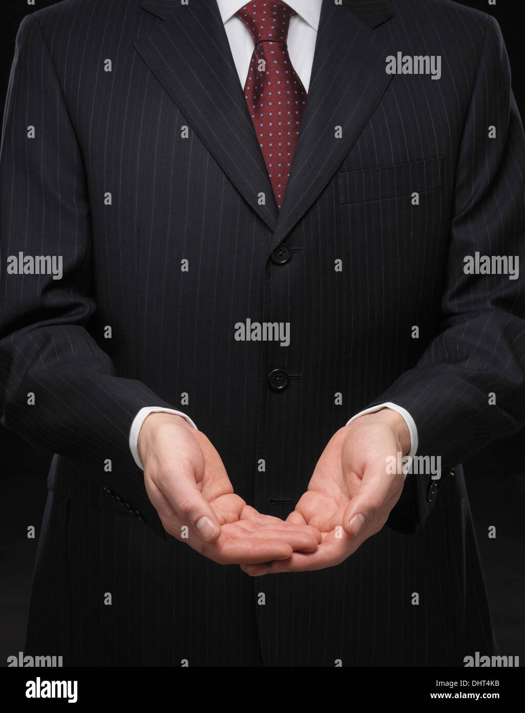 Man in Business Suit and Burgundy Tie Cupping his Hands Together Stock ...
