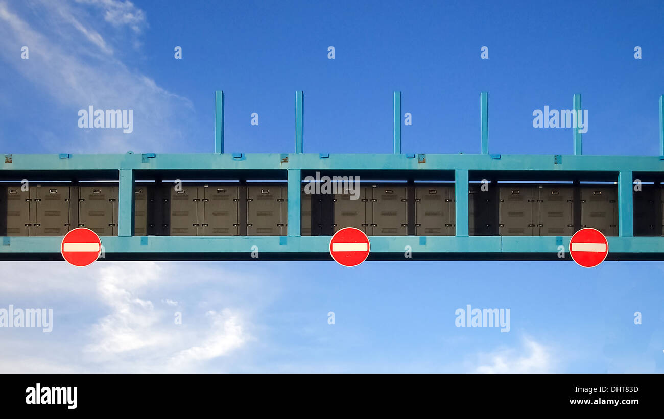 three stop signs attached to a sign above a road Stock Photo - Alamy