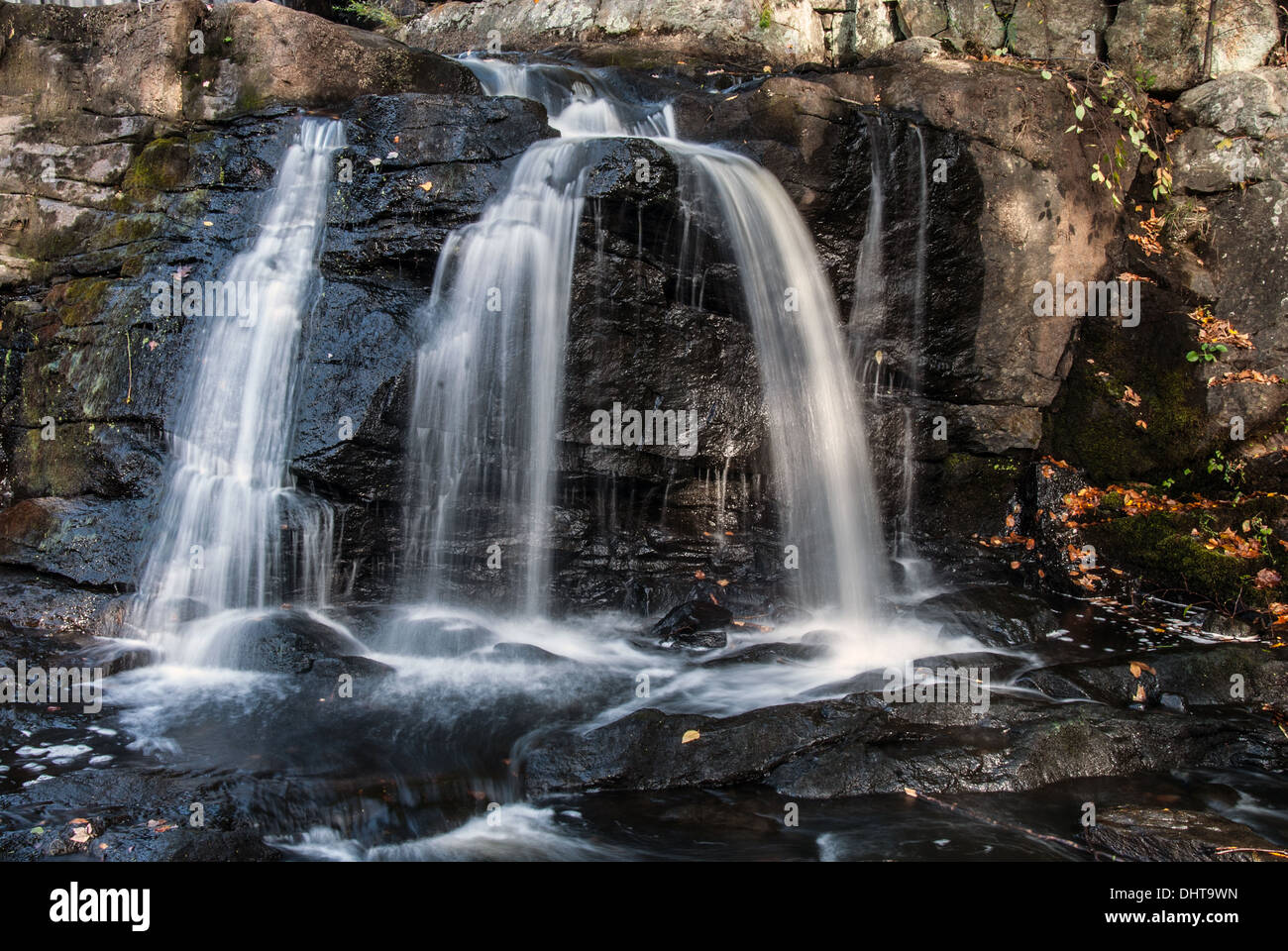 Water flowing at full force at a waterfall Stock Photo - Alamy