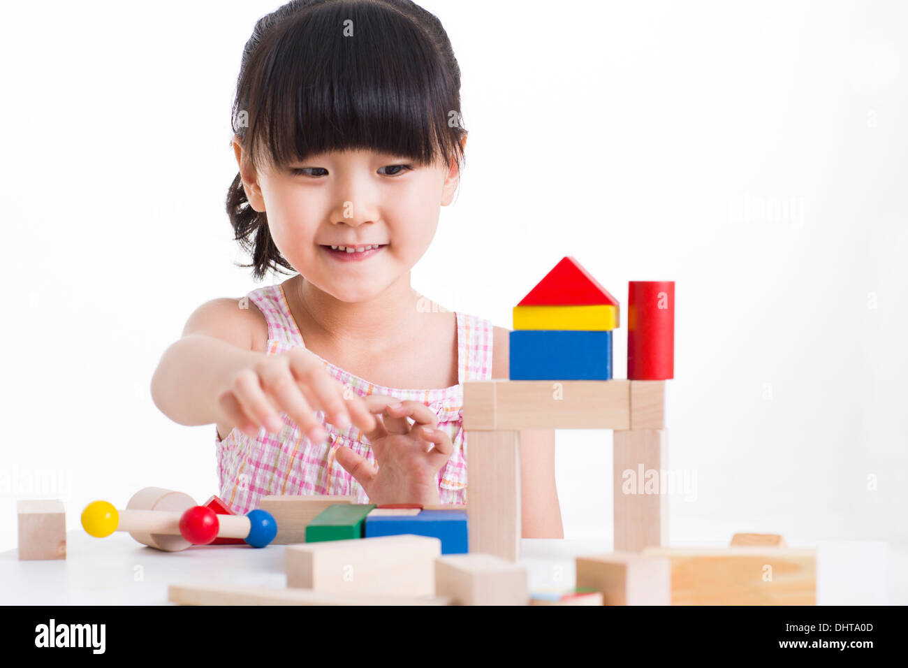 Little girl playing with building blocks Stock Photo - Alamy