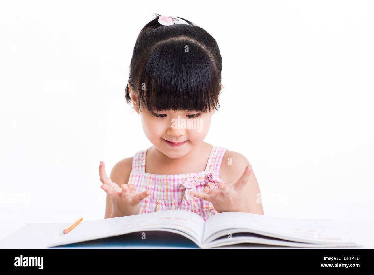 Happy girl doing homework Stock Photo - Alamy