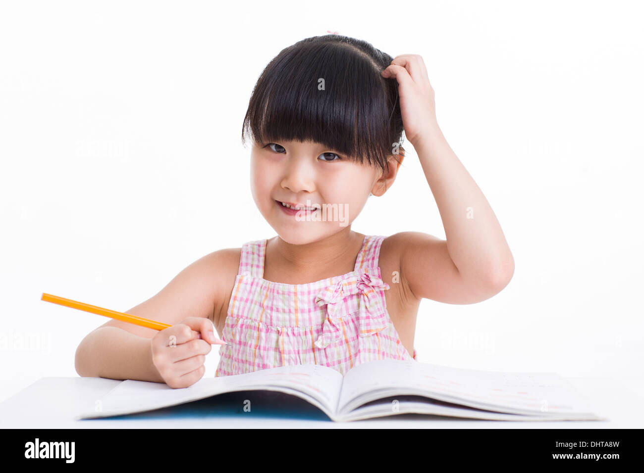 Happy girl doing homework Stock Photo - Alamy