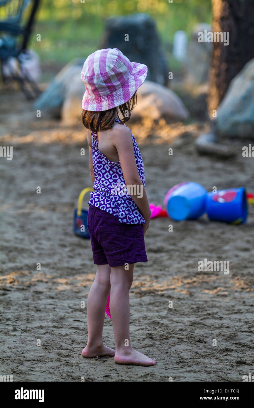 Model released young girl, outdoors, playing badminton in the sand ...