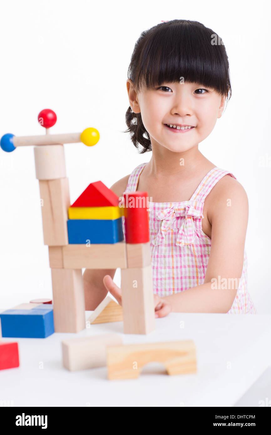 Little girl playing with building blocks Stock Photo - Alamy