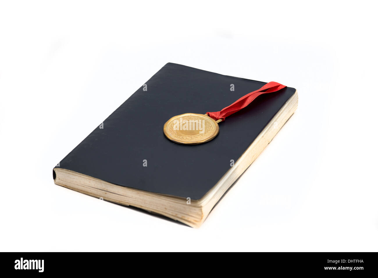 A book and medal isolated on white background concept of graduation ...