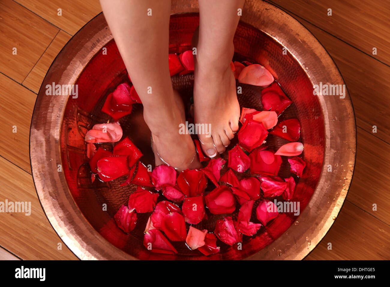 Woman's feet in the basin filling with water and rose leaf Stock Photo ...