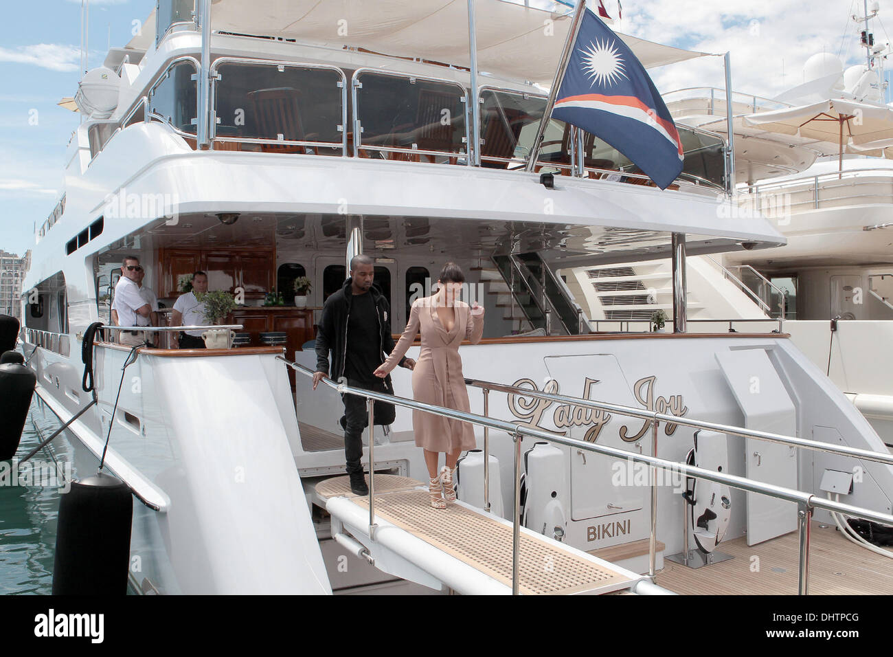 Kanye West and Kim Kardashian disembarking a yacht during the 65th ...